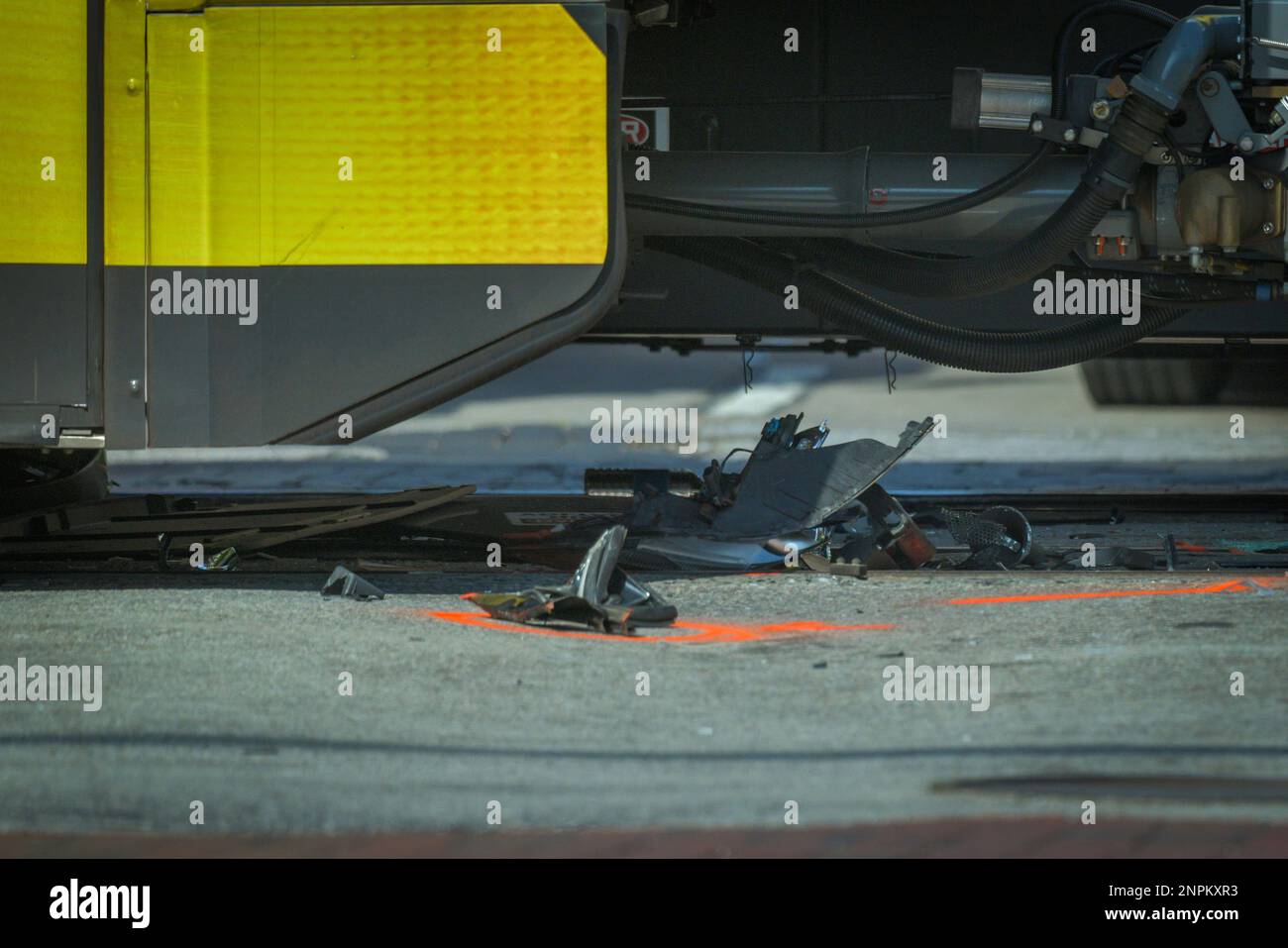 Debris is seen below a light rail train following an accident between a ...