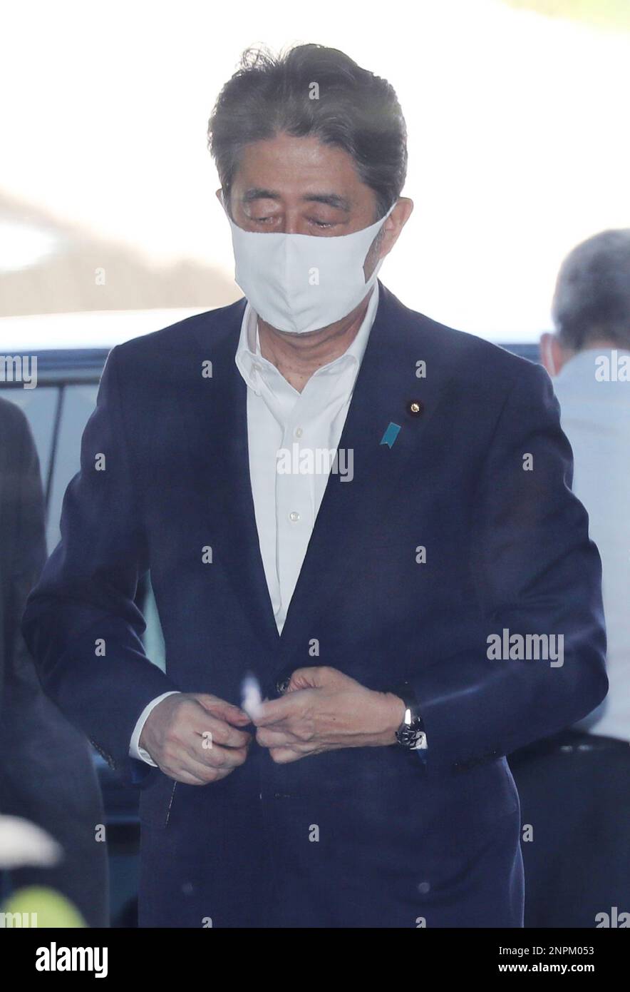Japan's Prime Minister Shinzo Abe wearing a face mask arrives at Prime ...