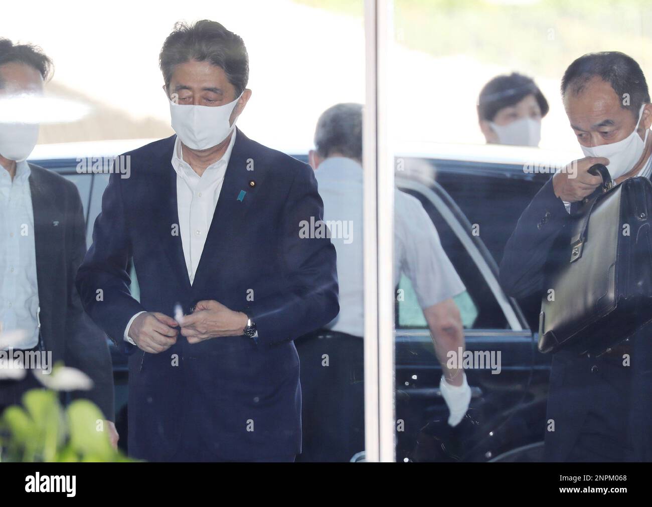 Japan's Prime Minister Shinzo Abe wearing a face mask arrives at Prime ...