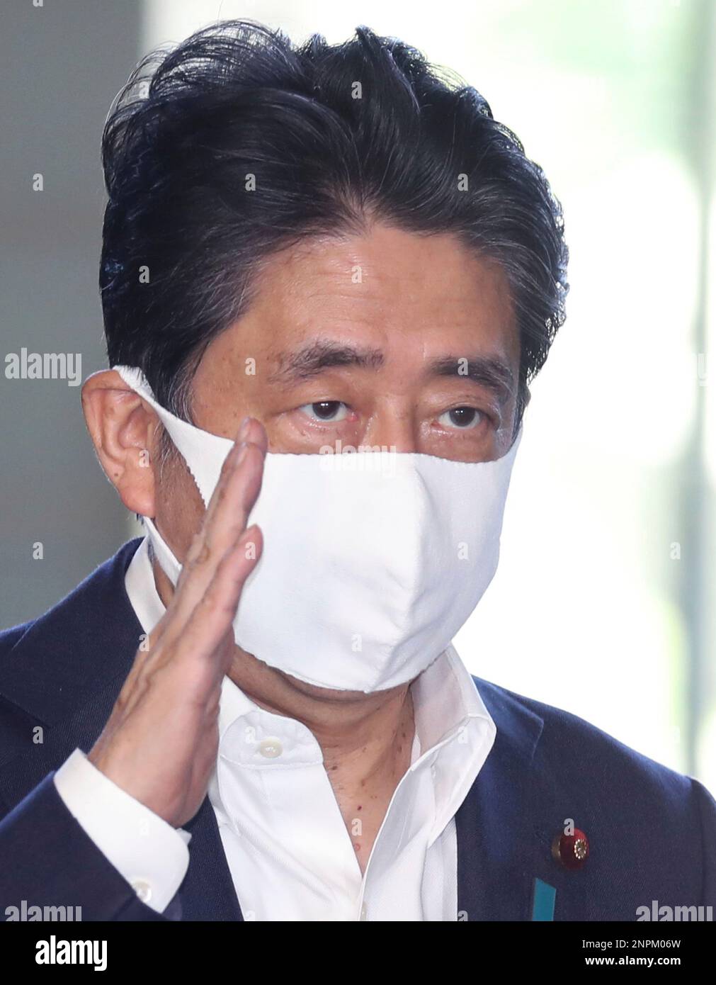 Japan's Prime Minister Shinzo Abe wearing a face mask arrives at Prime ...