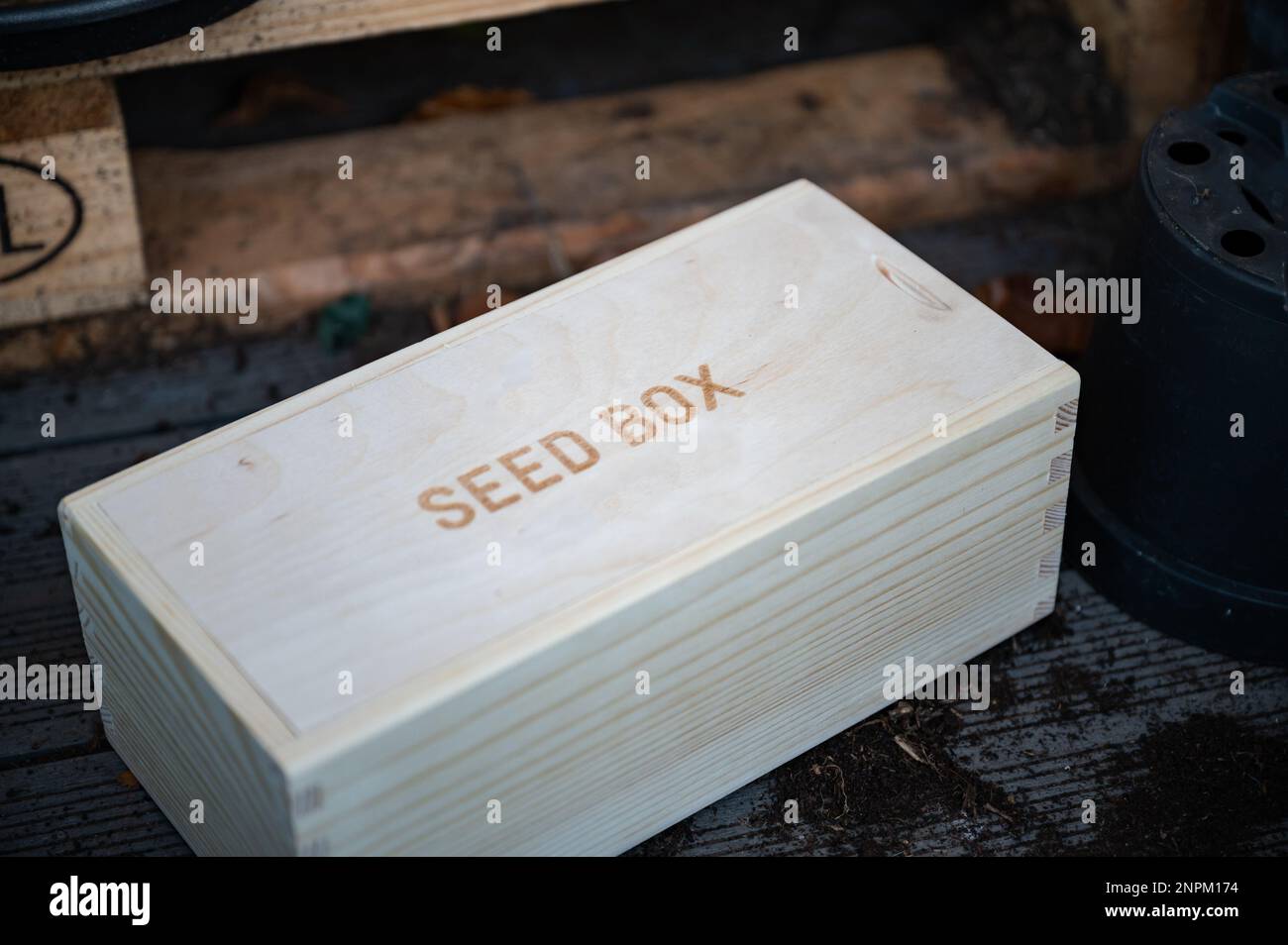 Close-up wooden Seed Box standing on the balcony ground with soil and ...