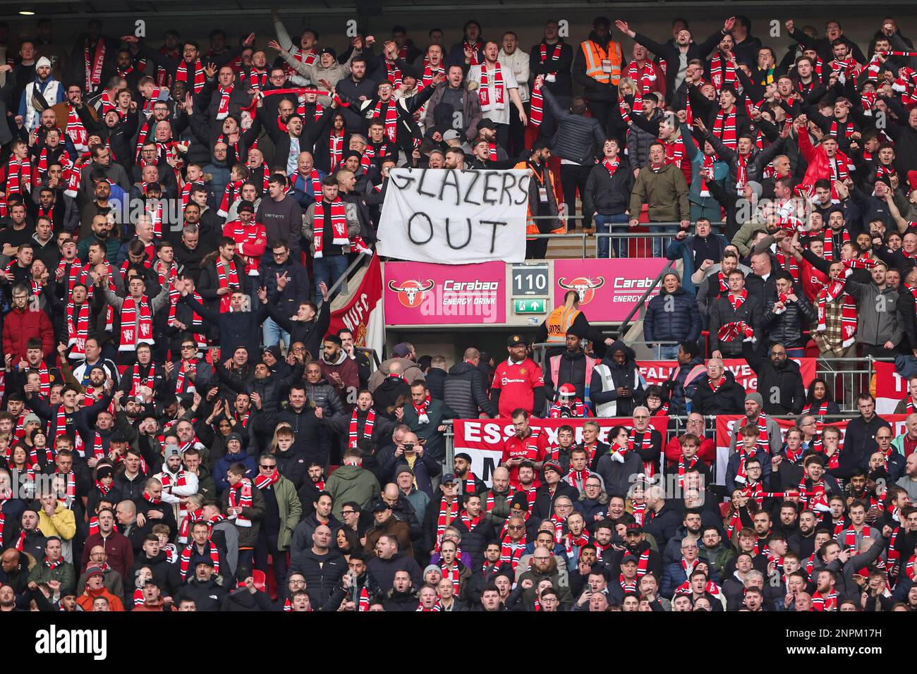 Manchester United fans hold up a Glazers Out Banner during the Carabao ...