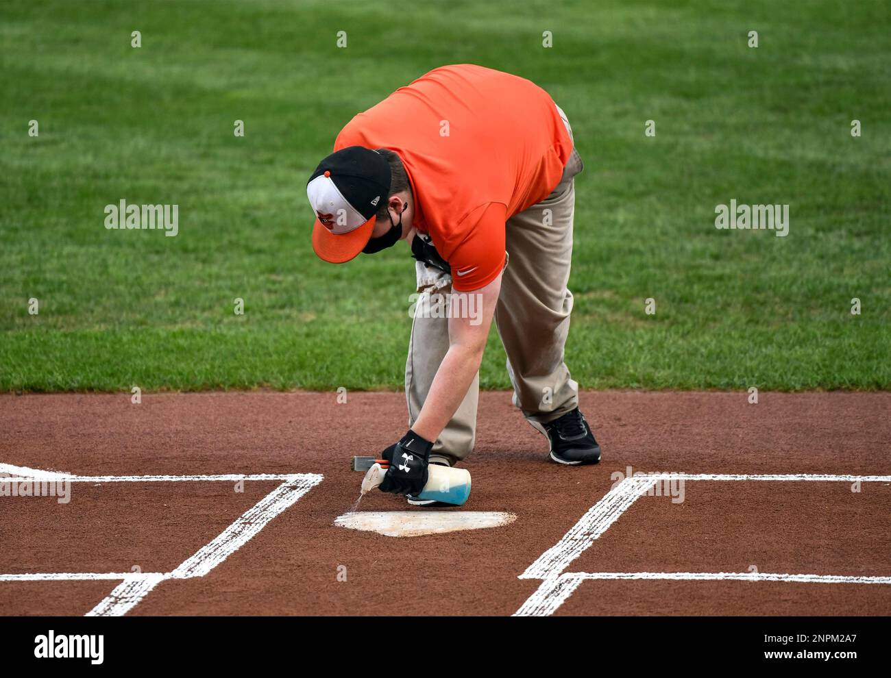 BALTIMORE, MD - AUGUST 17: Home plate is cleaned off by a grounds crew ...