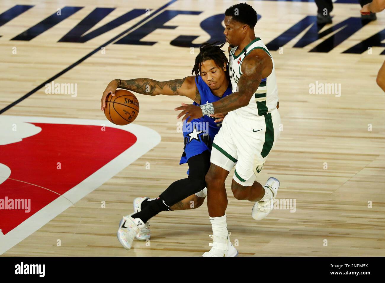 Orlando Magic guard Markelle Fultz, left, drives as Milwaukee Bucks guard Eric Bledsoe (6 ...