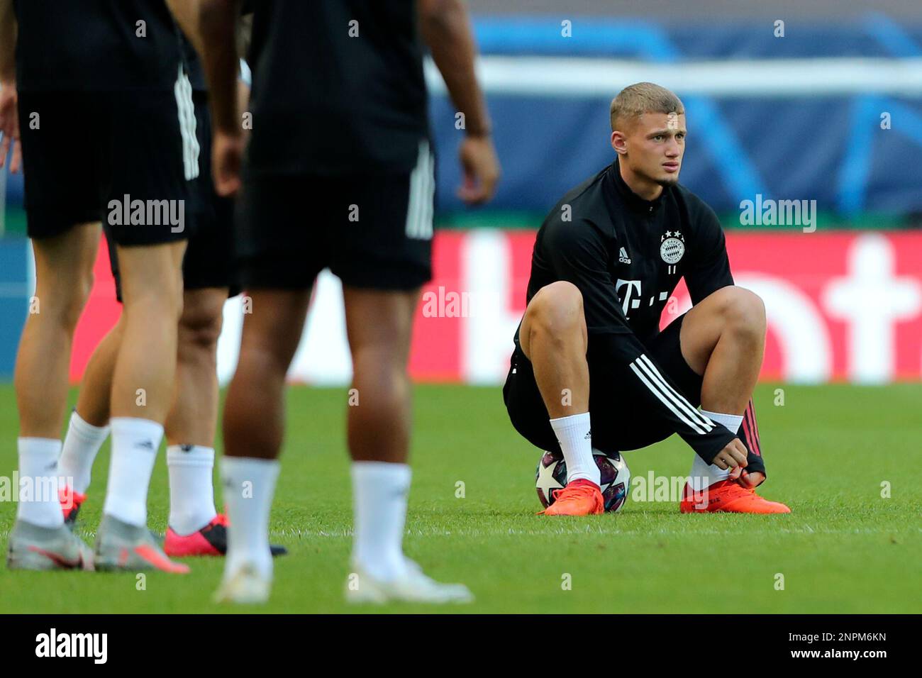 Bayern's Mickael Cuisance ties his boots during a training session at ...