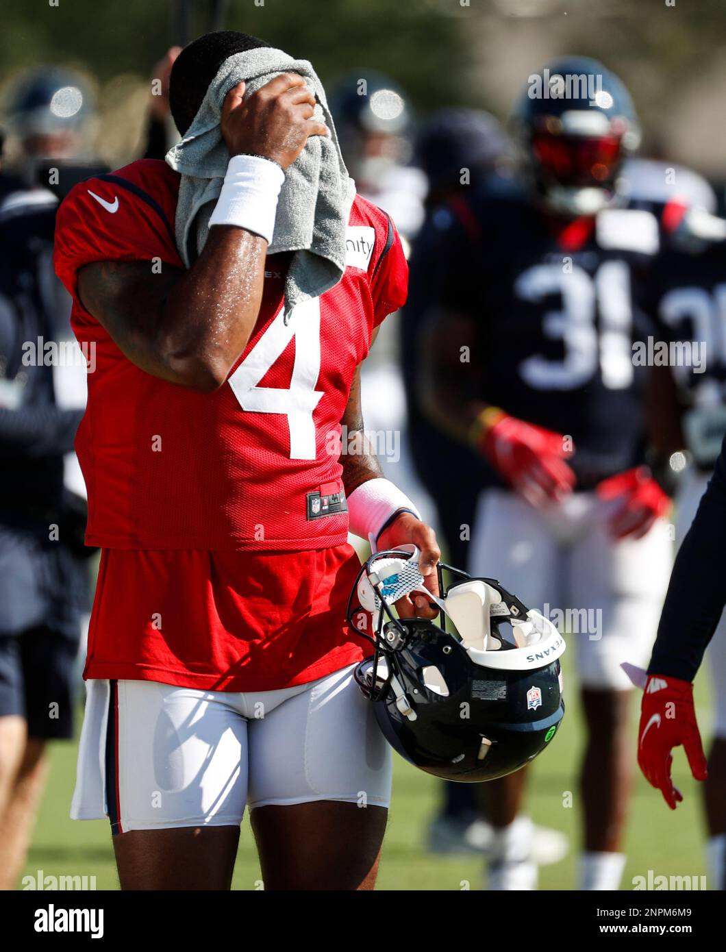 Houston Texans quarterback Deshaun Watson wipes his face with a towel ...