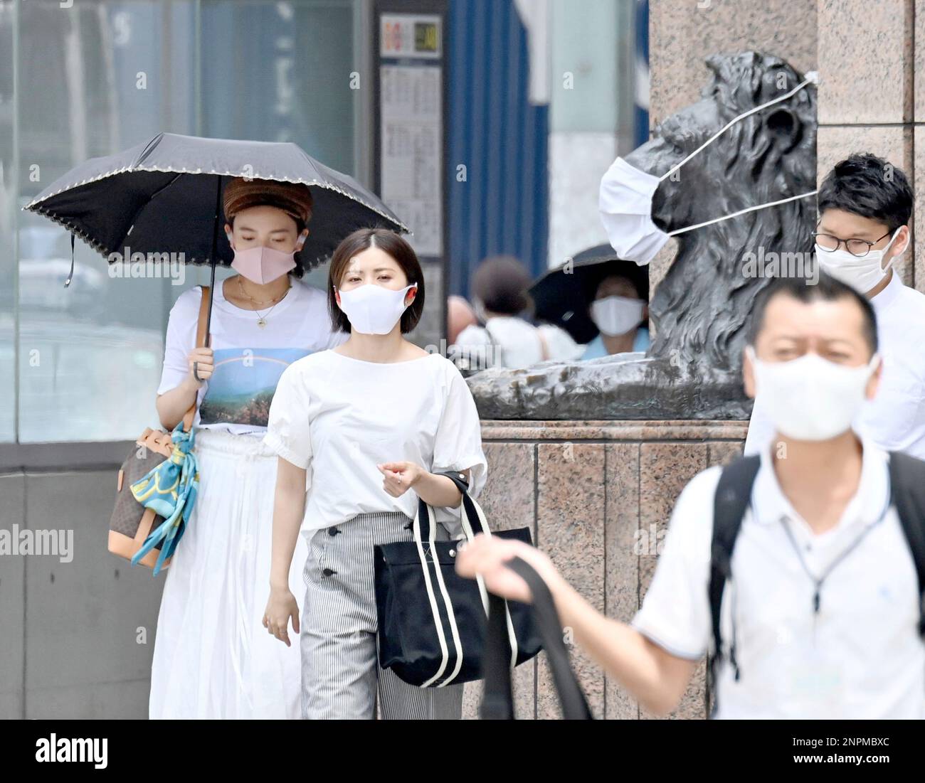 People wearing masks are seen at Ginza district in Tokyo on Aug. 17 ...