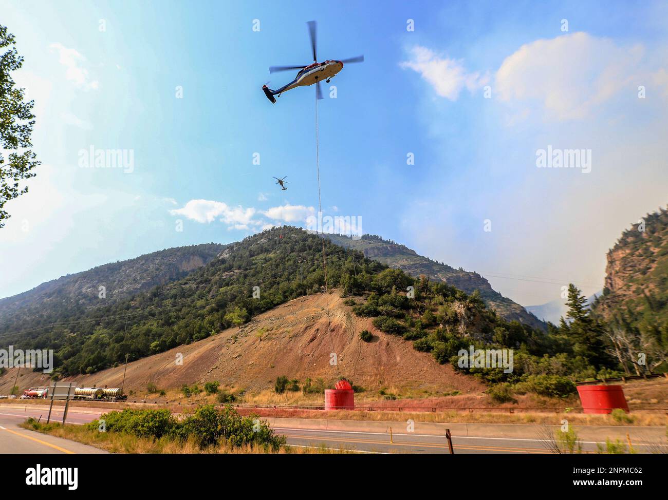 Helicopters fill up with fire retardant slurry to fight the Grizzly ...