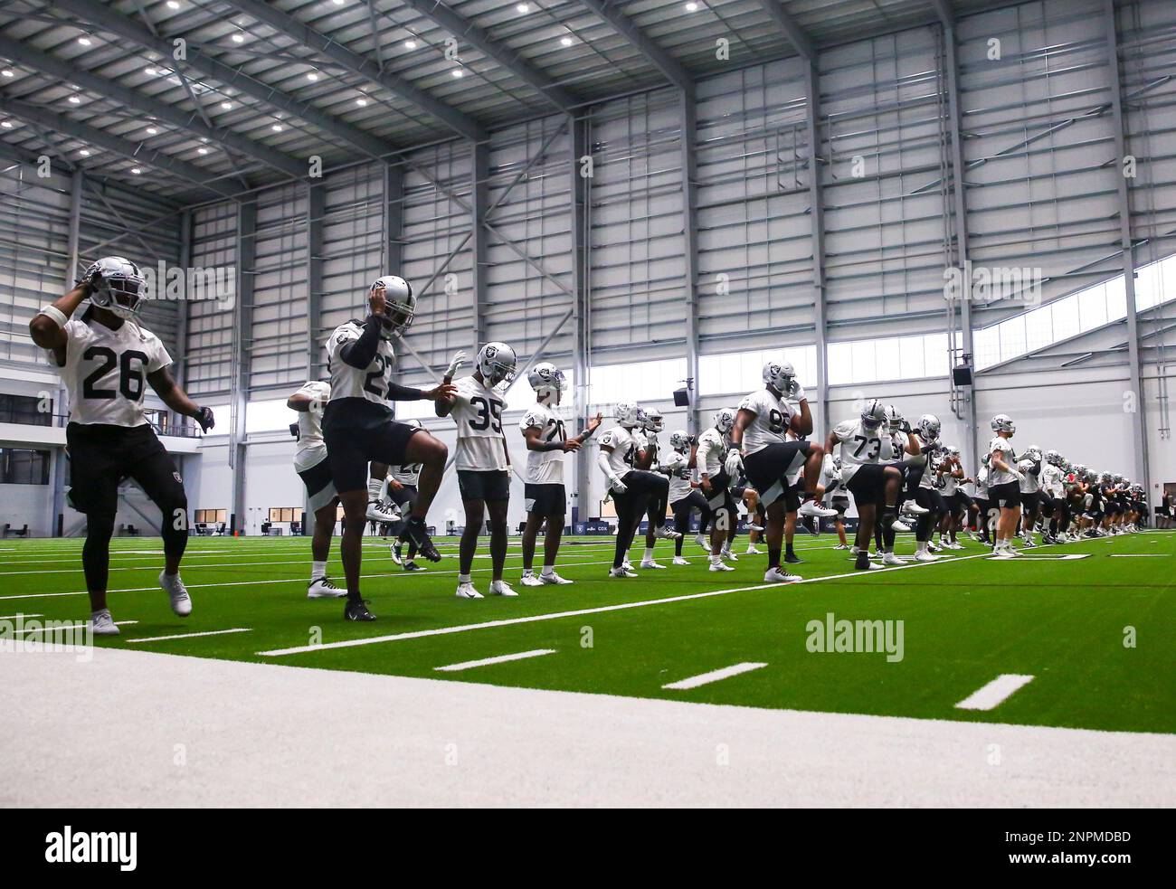 Las Vegas Raiders players warm up during an NFL football training camp ...