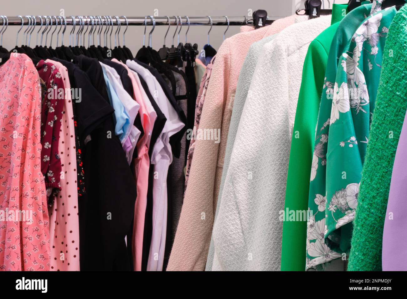 Fashion clothes on clothing rack - bright colorful closet. Closeup of ...