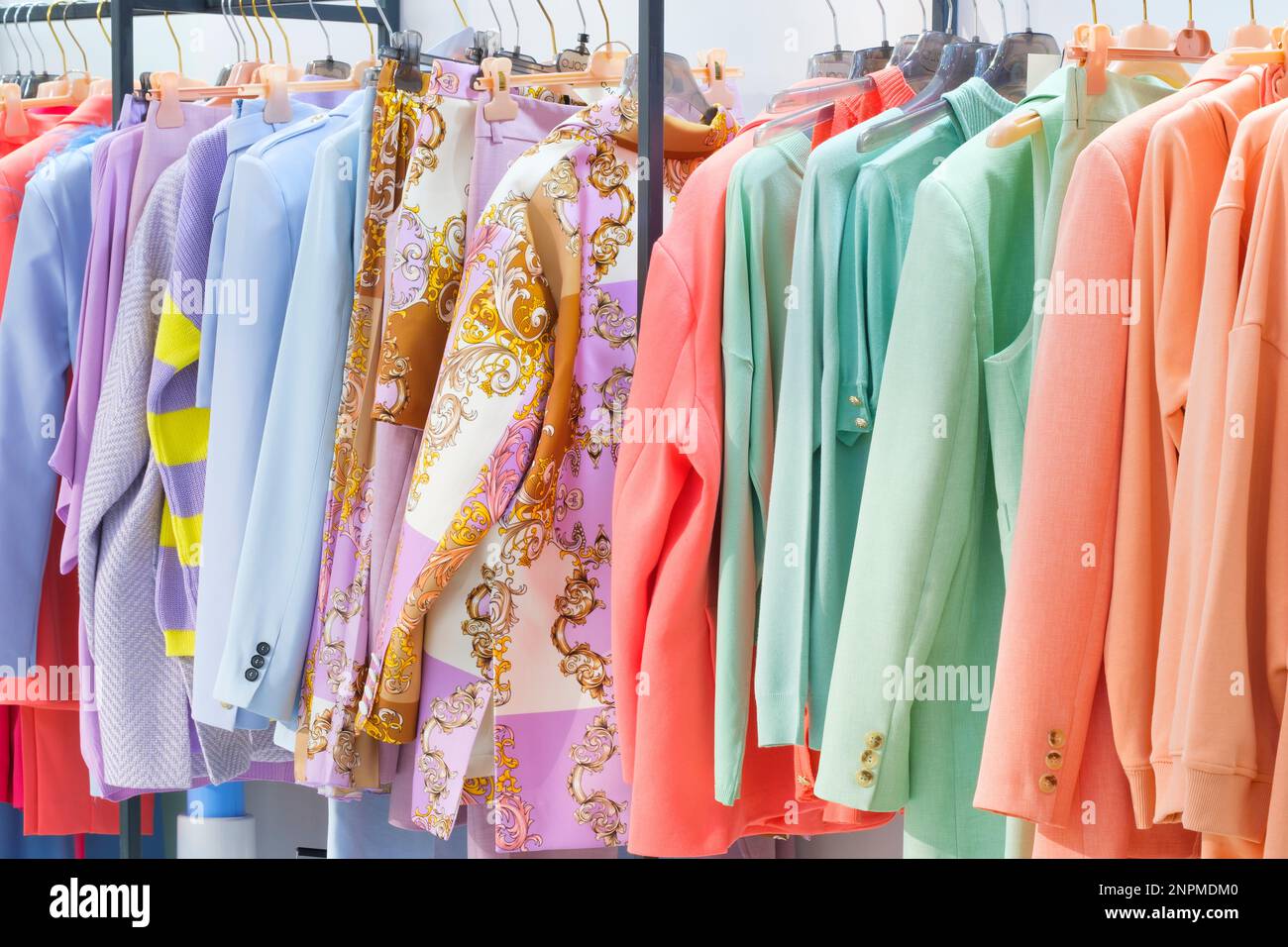 Fashion clothes on clothing rack - bright colorful closet. Closeup of ...