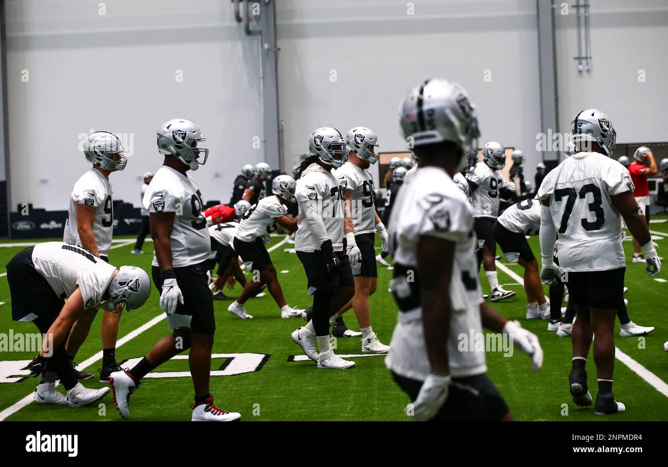Las Vegas Raiders players warm up during an NFL football training camp ...