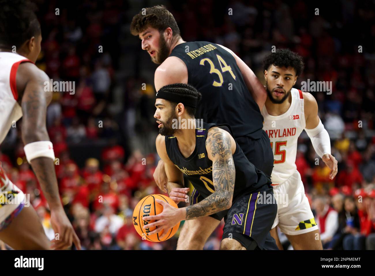 Northwestern guard Boo Buie (0) dribbles the ball as center Matthew ...