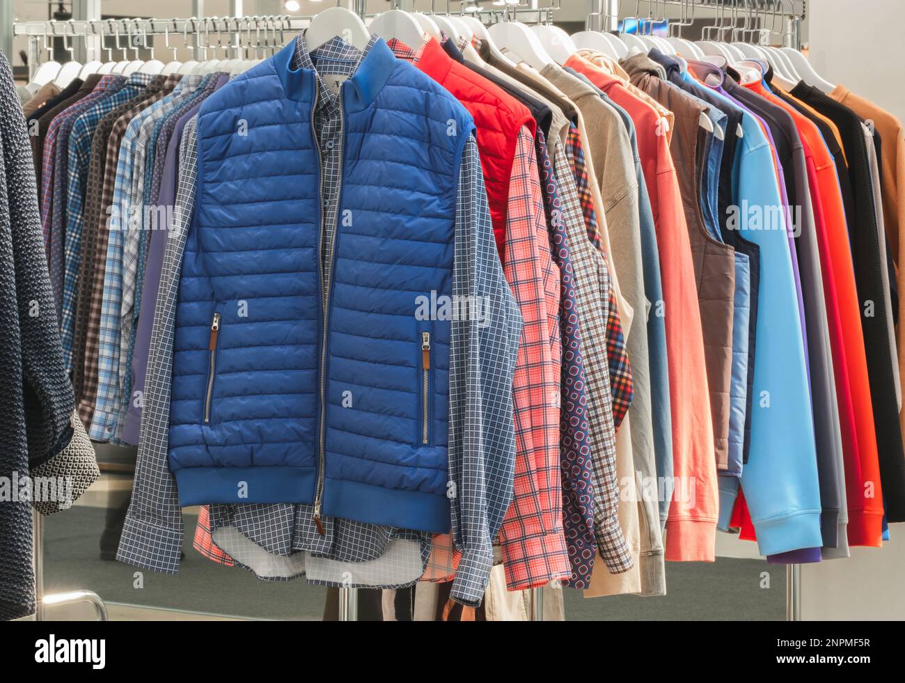 Fashion clothes on clothing rack - bright colorful closet. Closeup of ...
