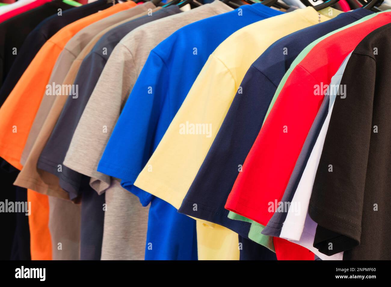 Fashion clothes on clothing rack - bright colorful closet. Closeup of ...