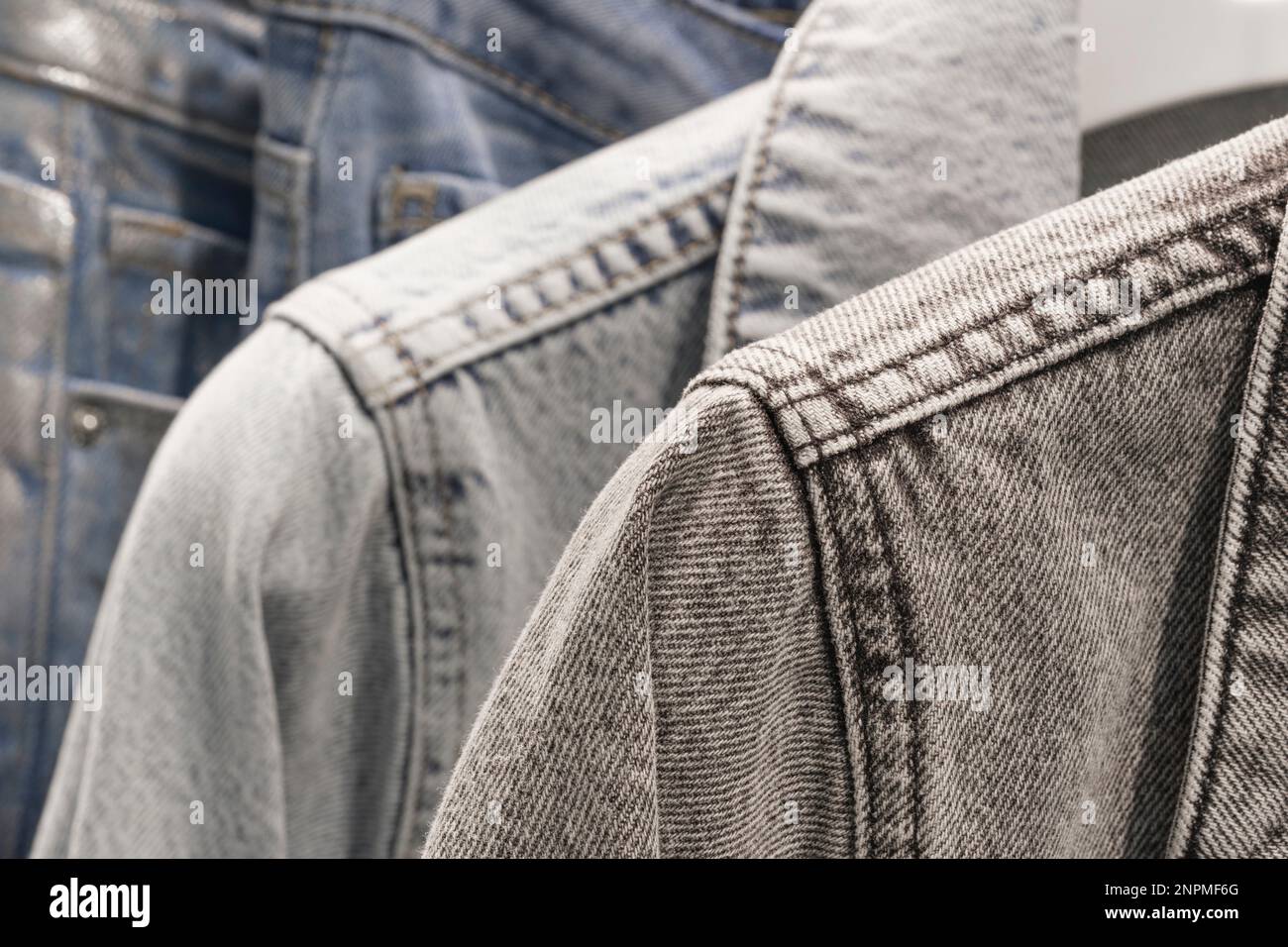Collection modern jeans denim jacket hanging on hangers in the market ...