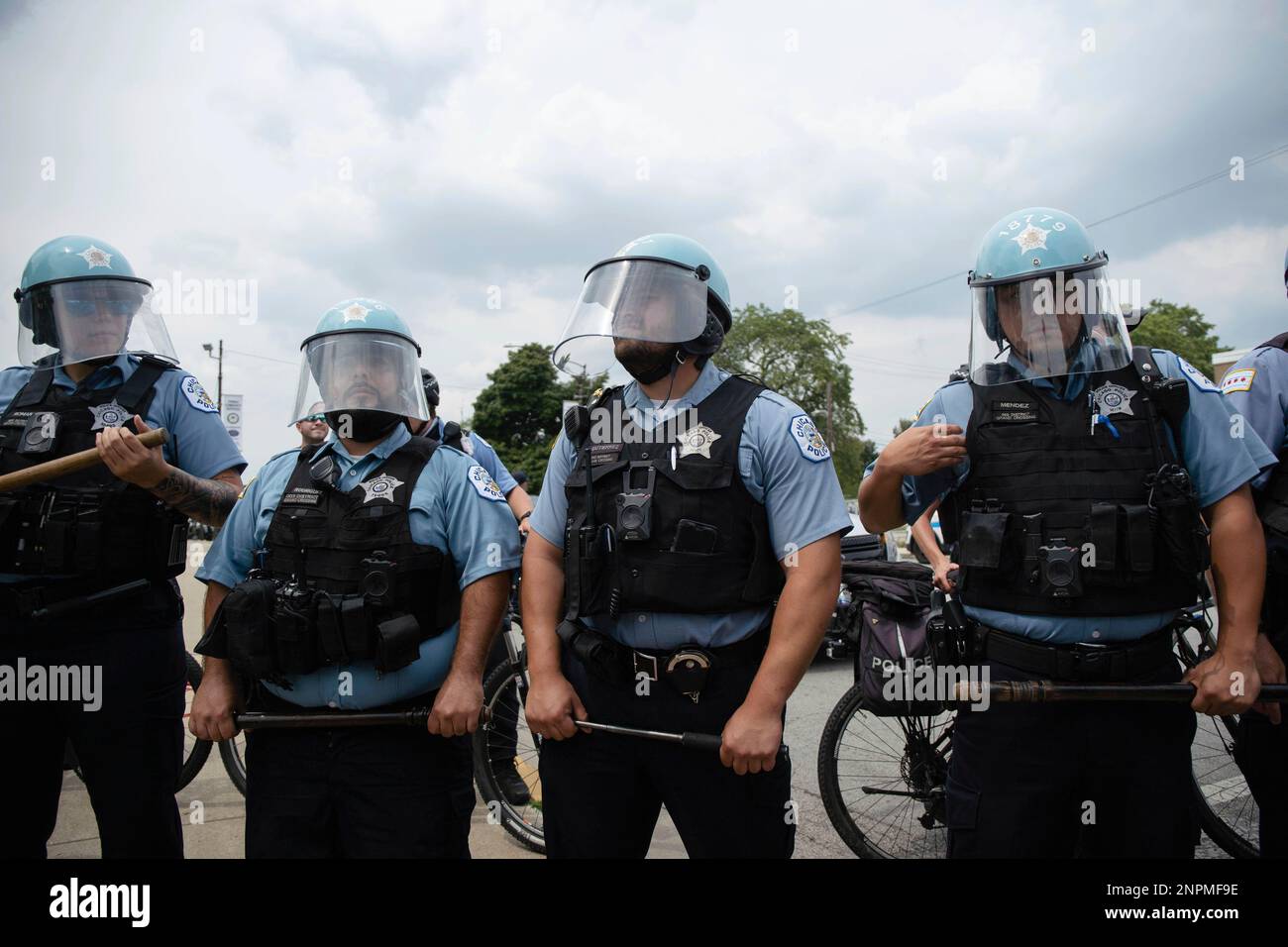 Police officers form a human barricade in the neighborhood of ...