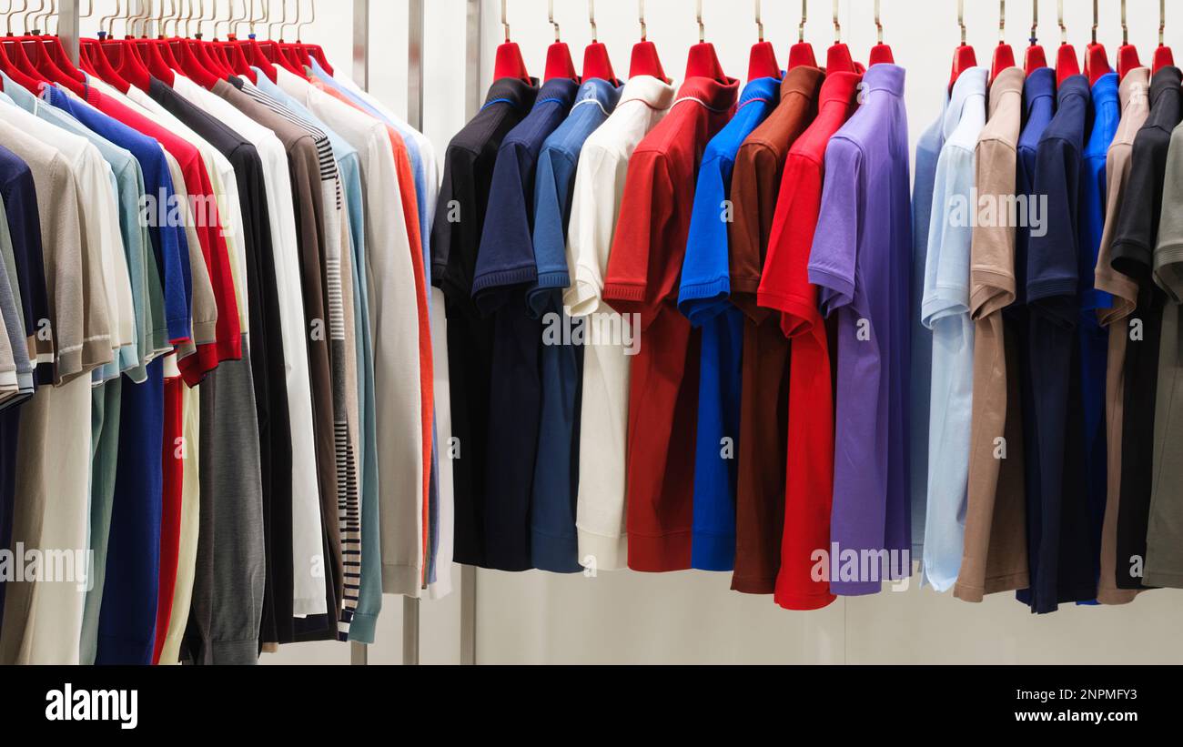 Fashion clothes on clothing rack - bright colorful closet. Closeup of ...