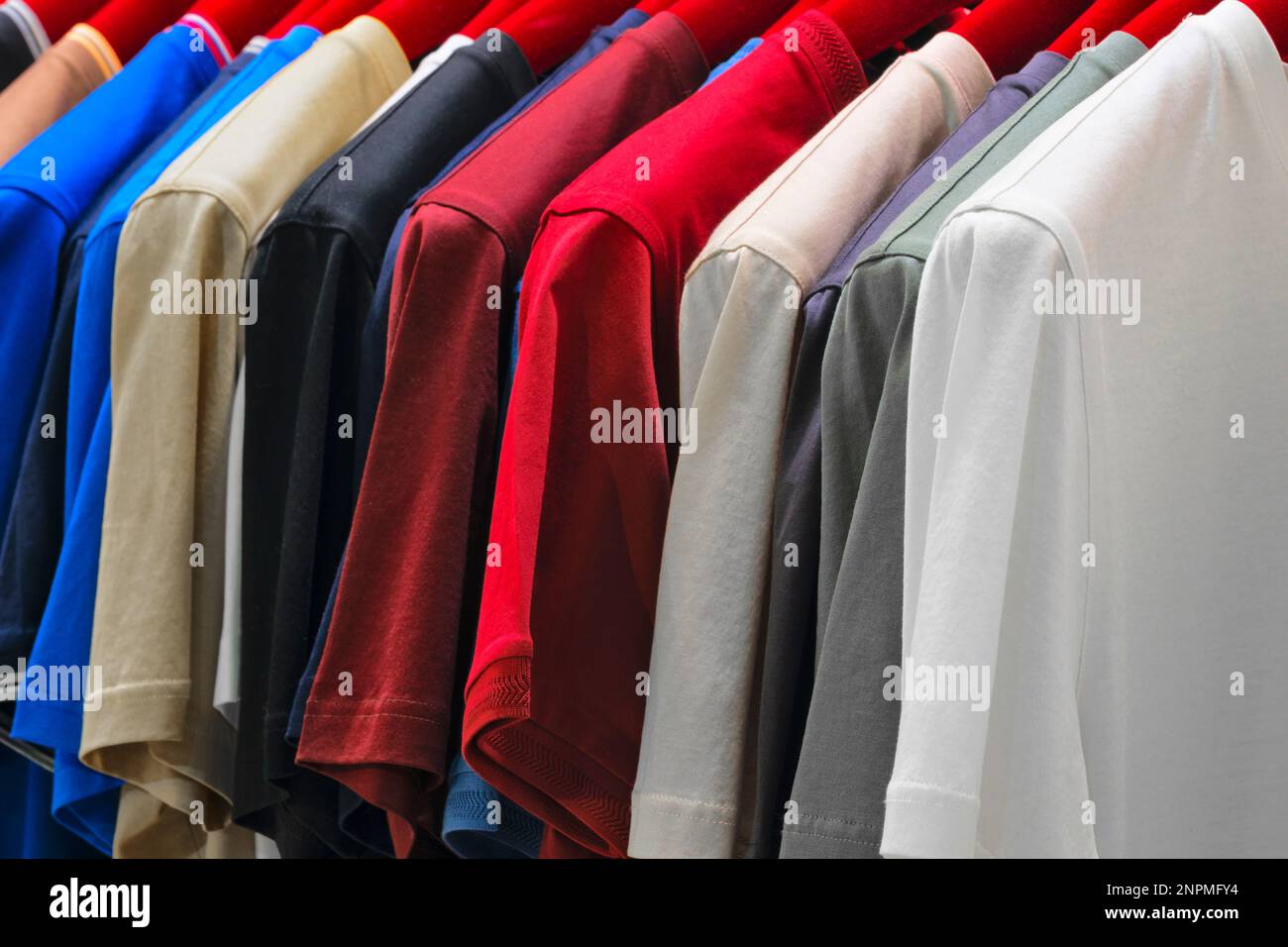 Fashion clothes on clothing rack - bright colorful closet. Closeup of ...