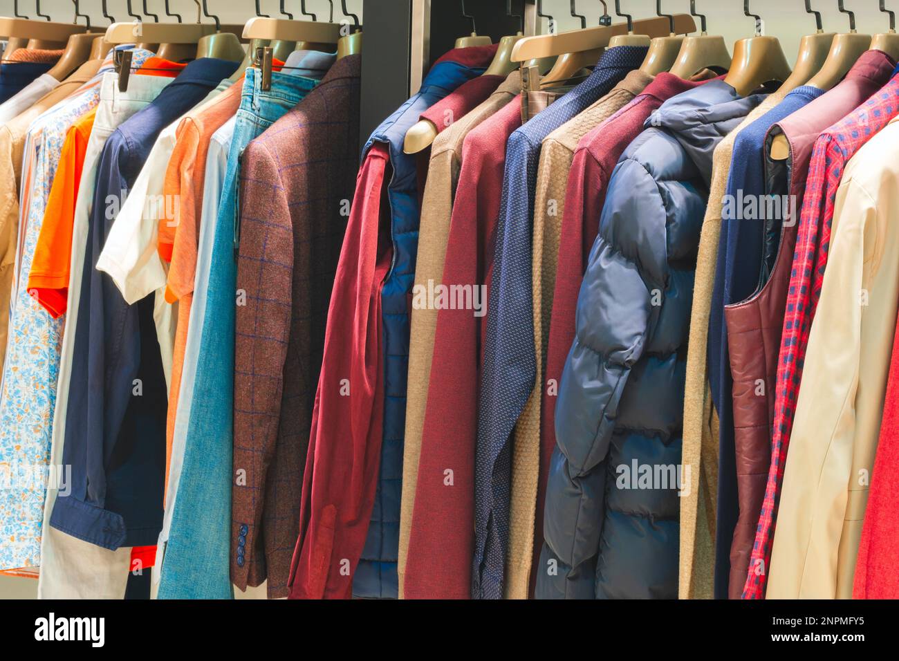 Fashion clothes on clothing rack - bright colorful closet. Closeup of ...