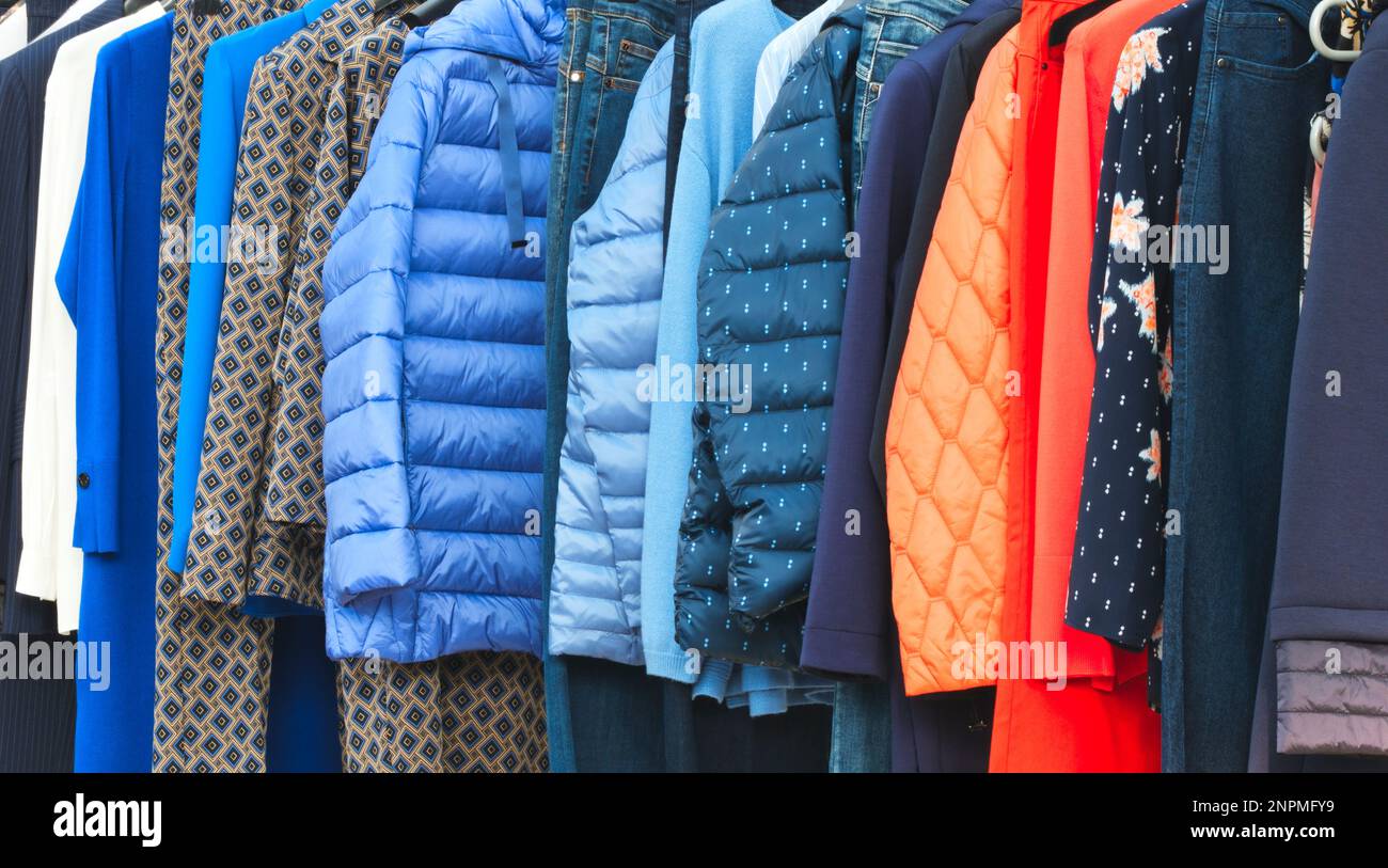 Fashion clothes on clothing rack - bright colorful closet. Closeup of ...