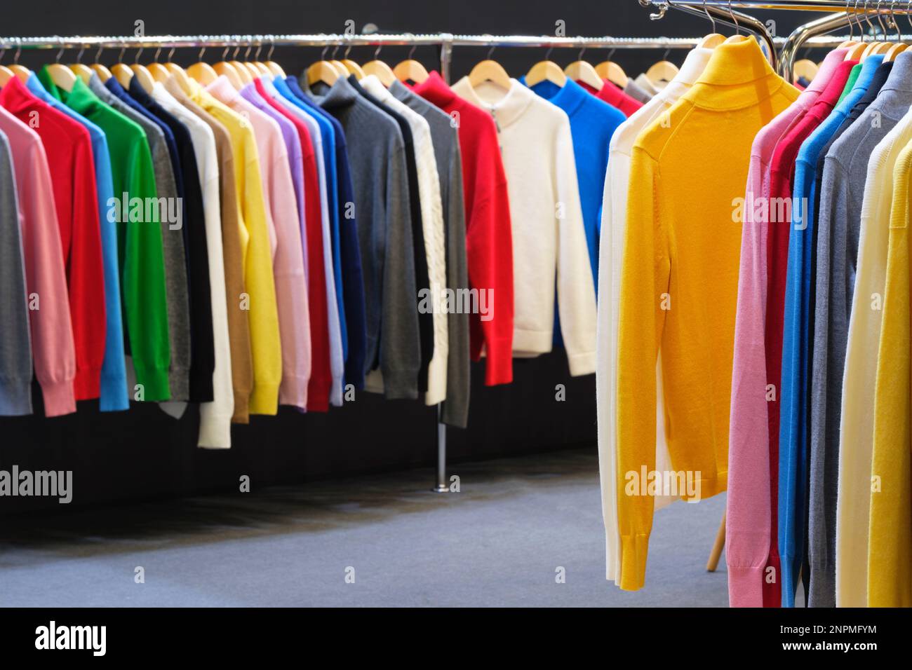 Fashion clothes on clothing rack - bright colorful closet. Closeup of ...