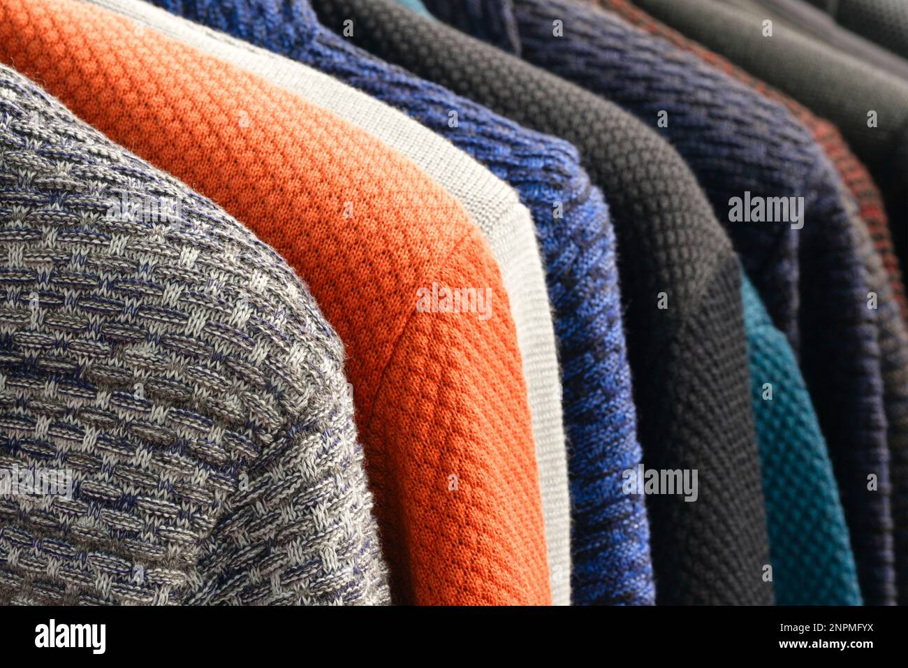 Fashion clothes on clothing rack - bright colorful closet. Closeup of ...