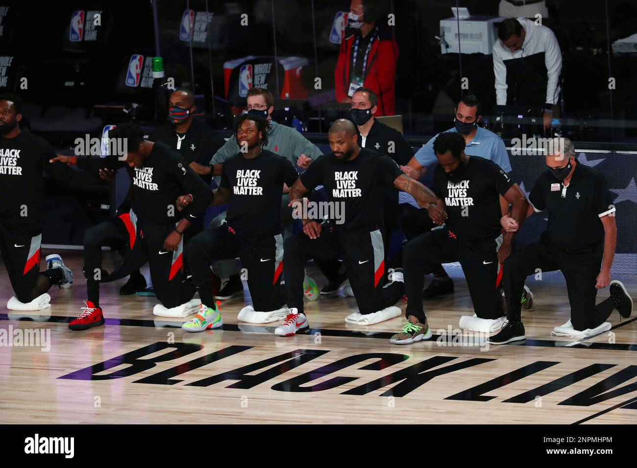 Members of the Houston Rockets kneel during the national anthem before ...
