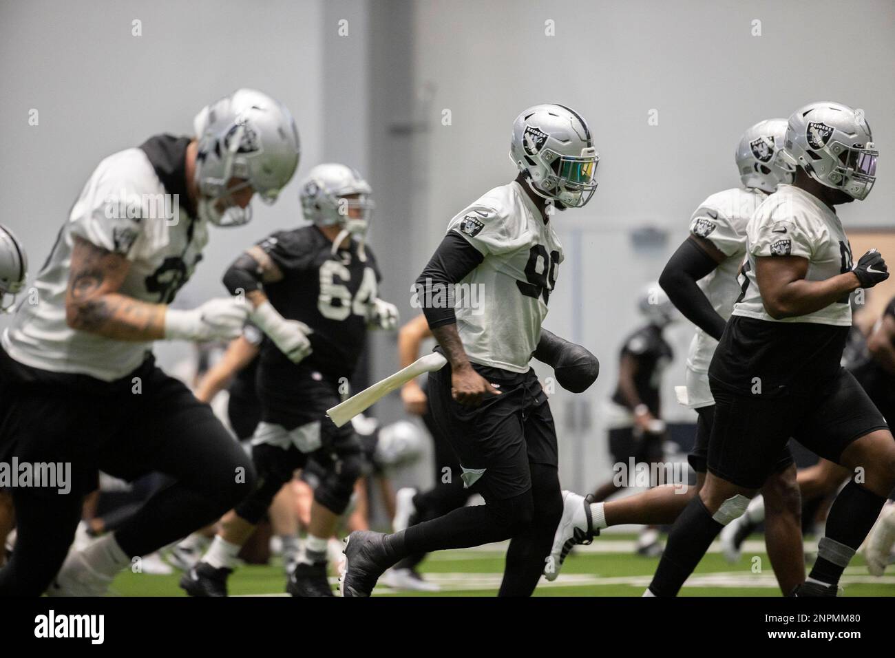 Raiders players warm up during an NFL football training camp practice ...