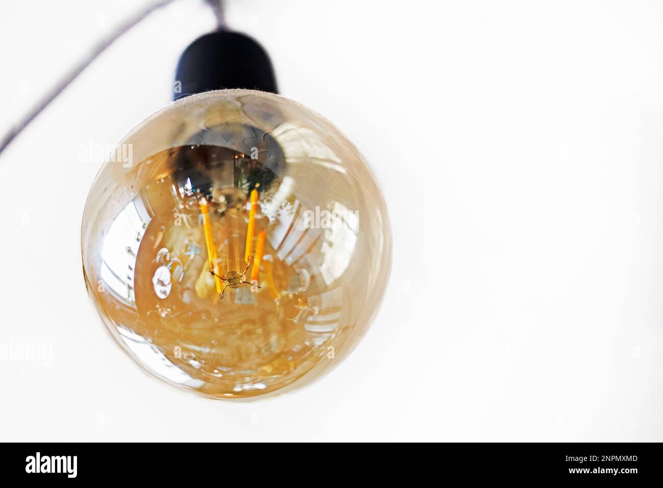 Close -up electric shut -off light bulb on a light wall, electricity ...