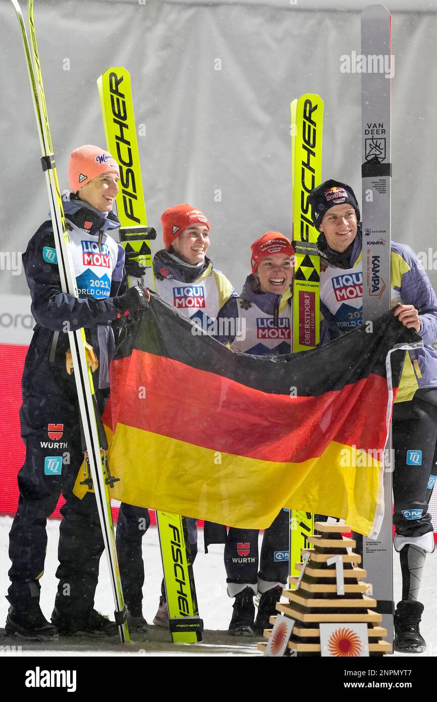 Members of team Germany celebrate their victory in the Ski Jumping ...