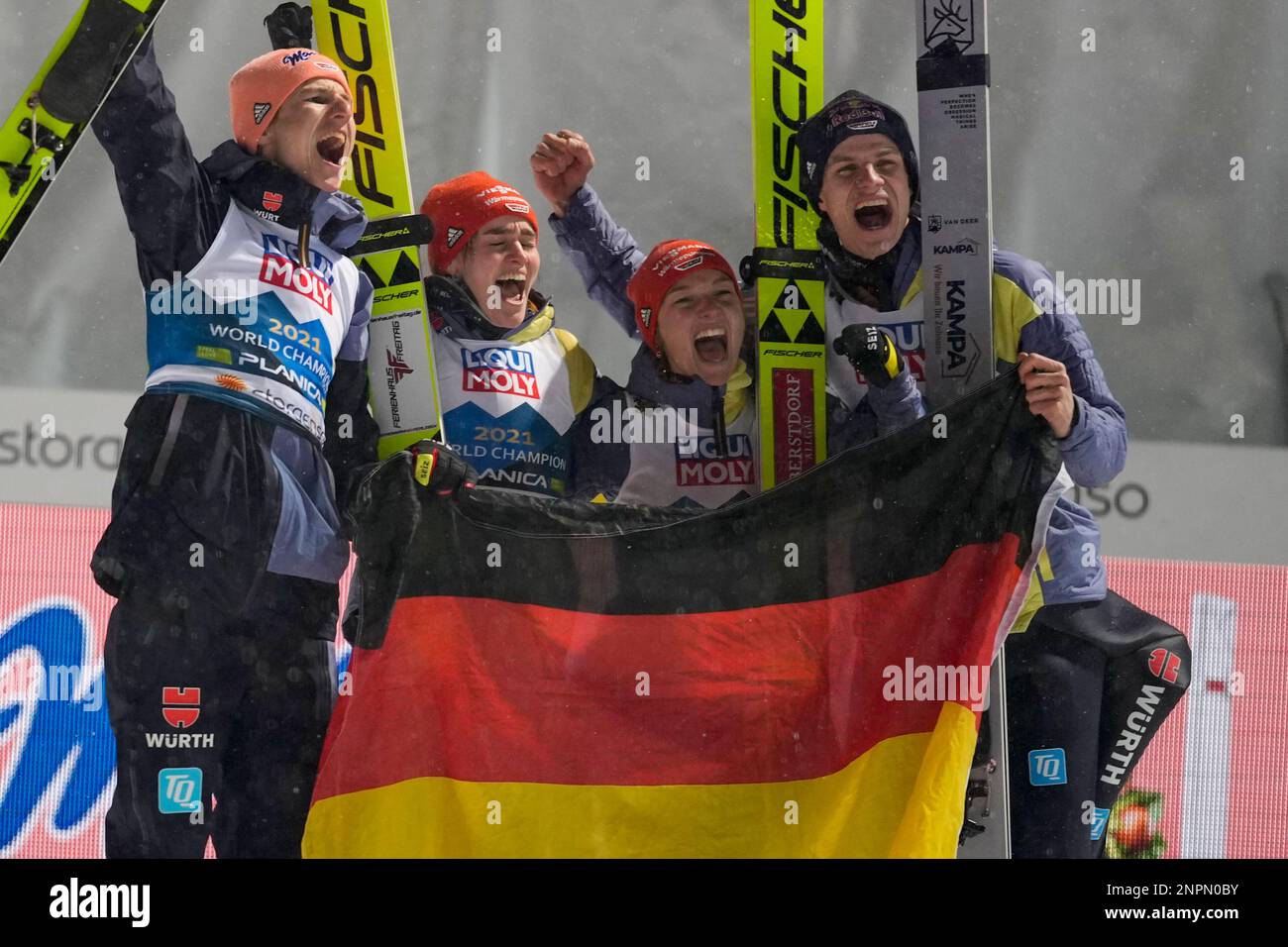 Members of team Germany celebrate their victory in the Ski Jumping ...