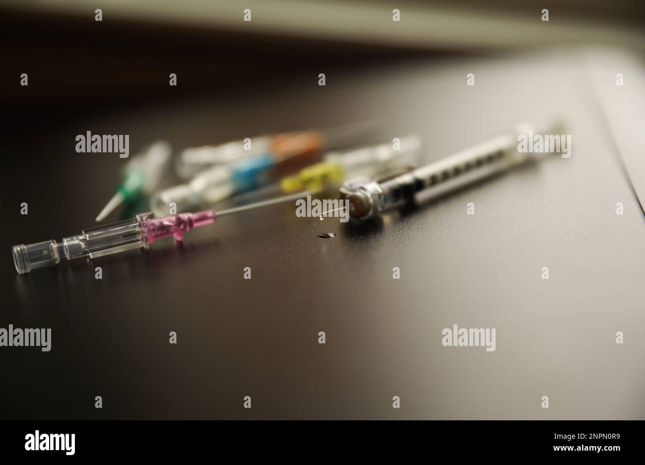 flu vaccine and needle syringes showing opioid crisis needle therapy ...