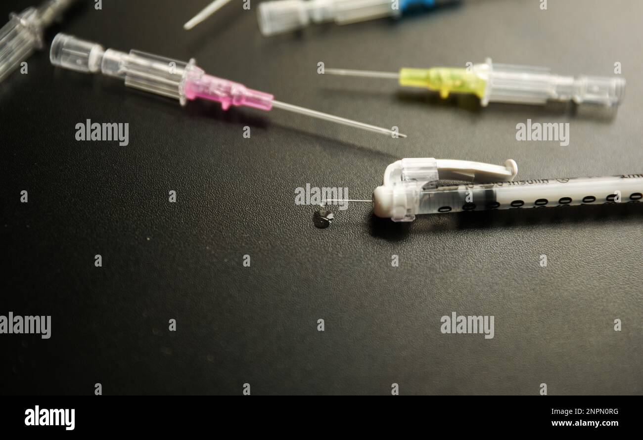 flu vaccine and needle syringes showing opioid crisis needle therapy ...