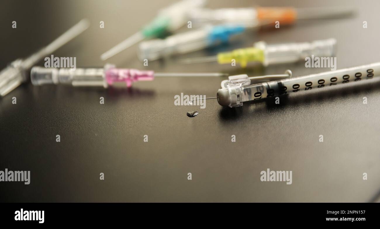 flu vaccine and needle syringes showing opioid crisis needle therapy ...