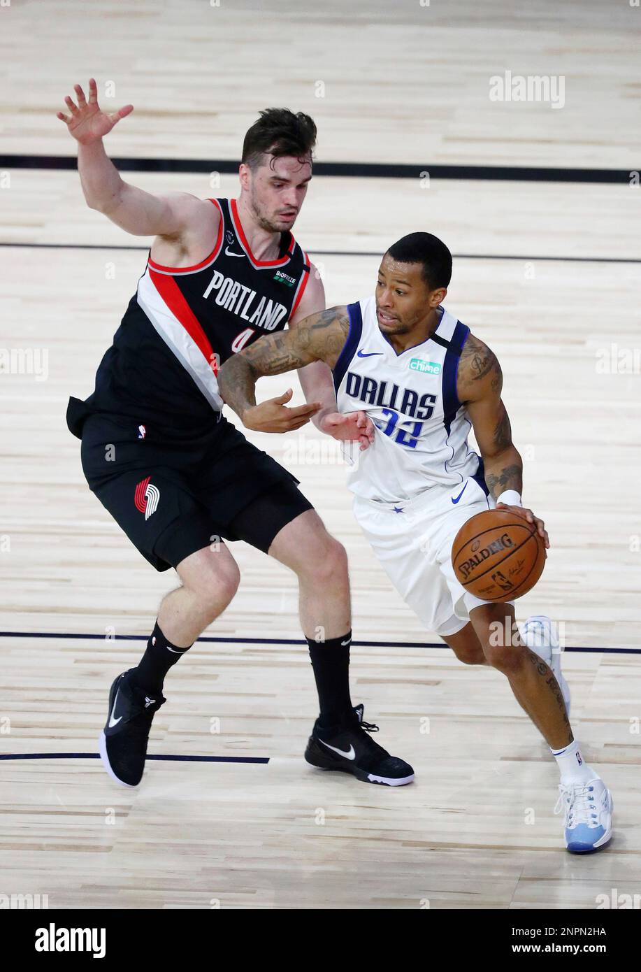 Dallas Mavericks guard Trey Burke, right, drives to the basket as ...
