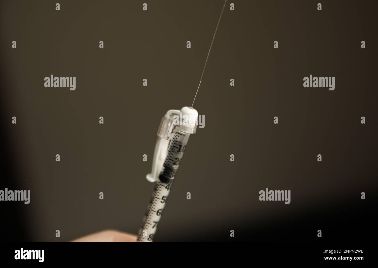 flu vaccine and needle syringes showing opioid crisis needle therapy ...