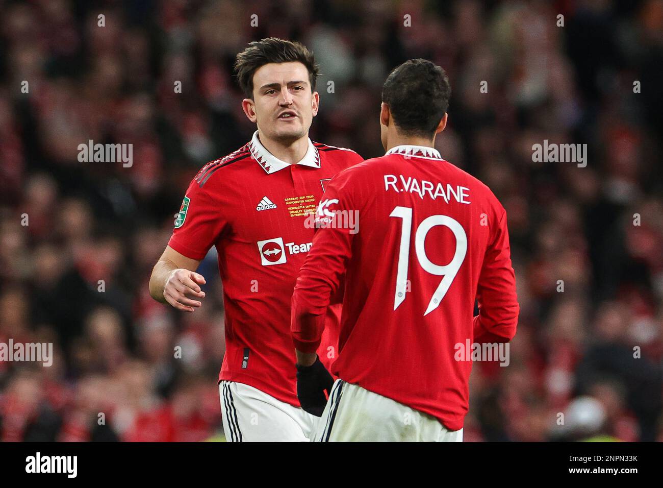 Harry Maguire #5 of Manchester United gives instructions to Raphaël ...