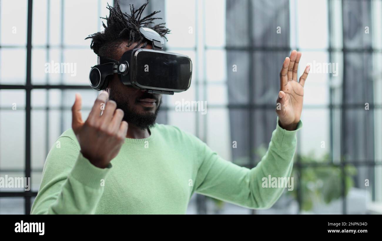 Cool handsome african american man put on virtual reality goggles for ...