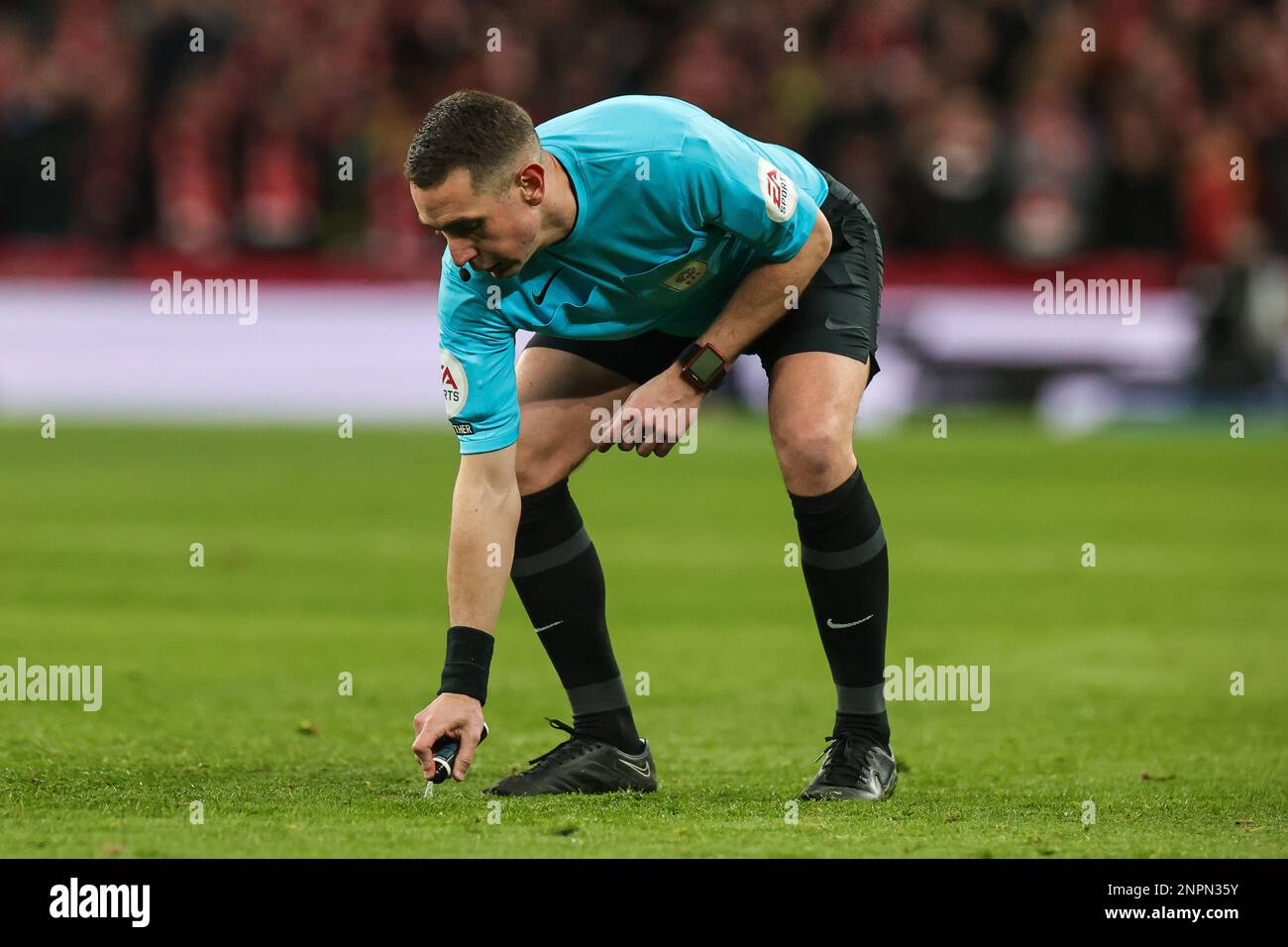 Referee David Coote marks the spot with his white spray during the ...