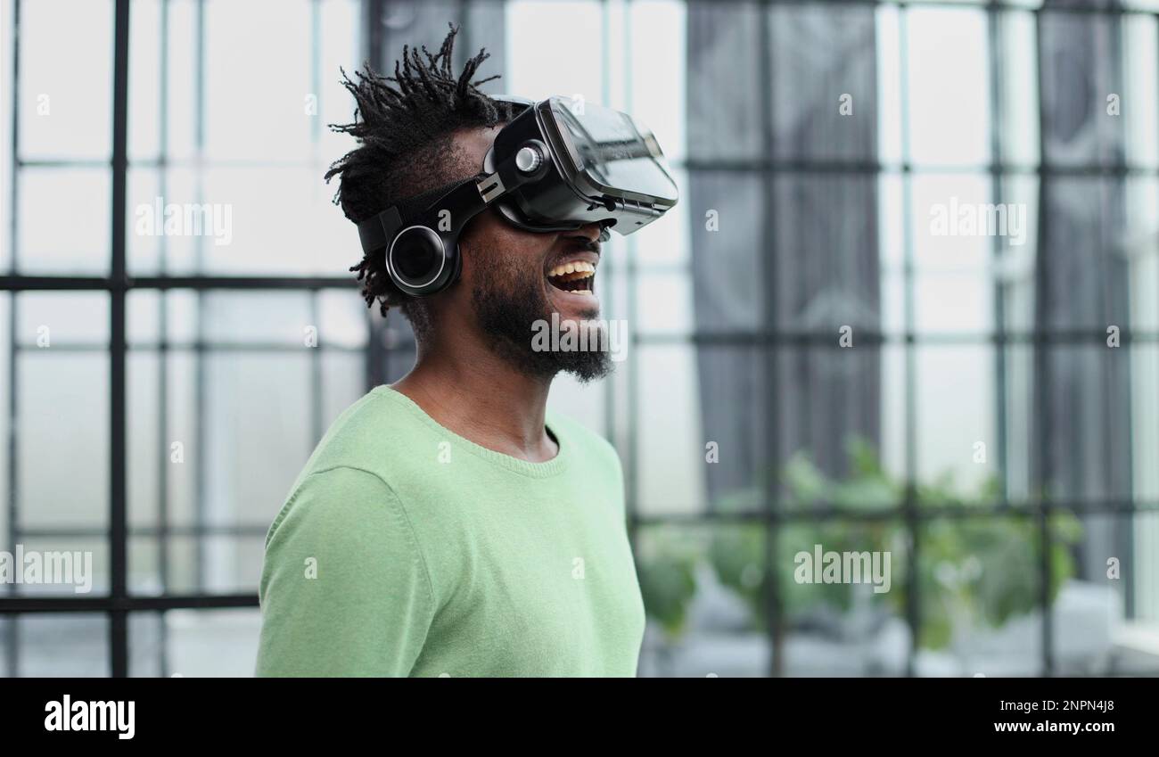 Cool handsome african american man put on virtual reality goggles for ...