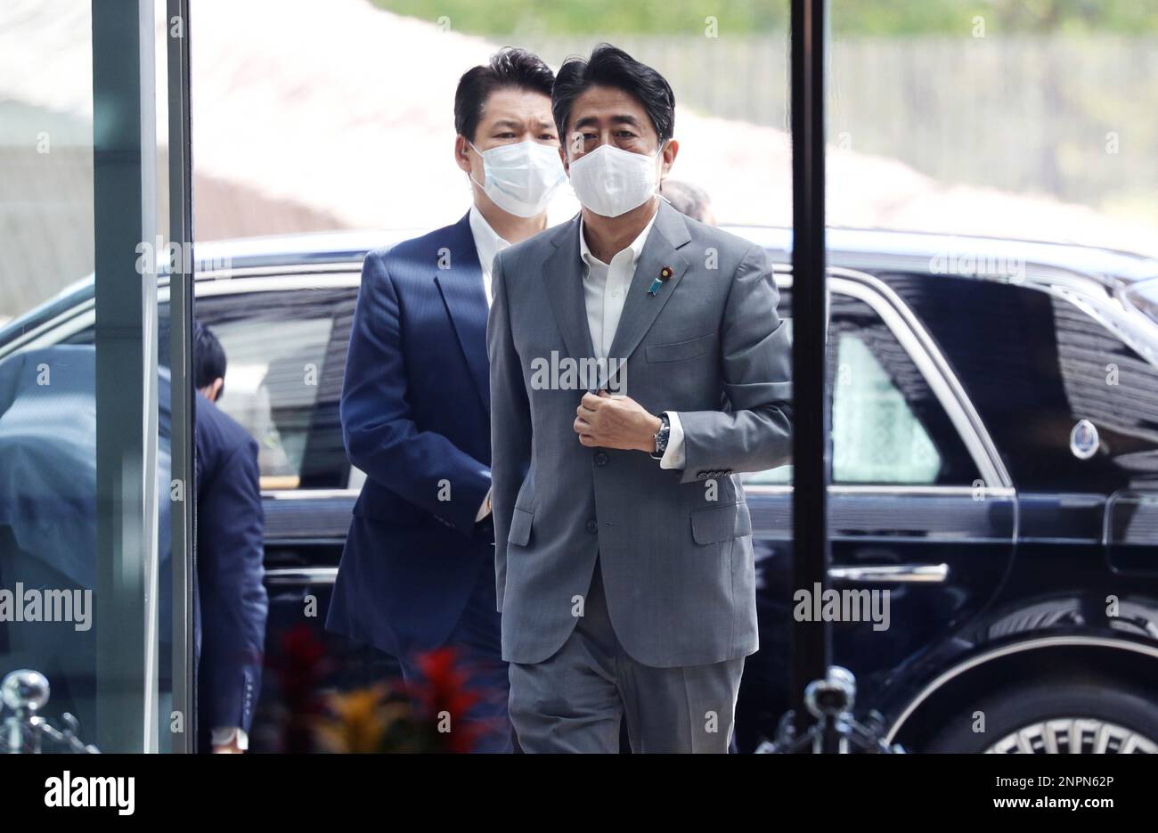 Japan's Prime Minister Shinzo Abe wearing a face mask arrives at Prime ...