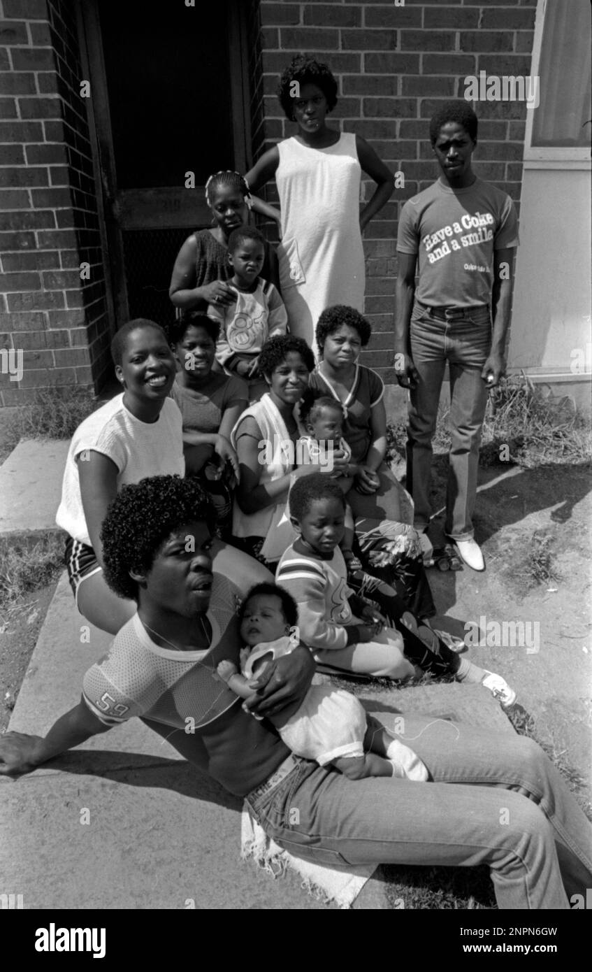 Annie Rogers (at right, in background, seated with child in lap ...