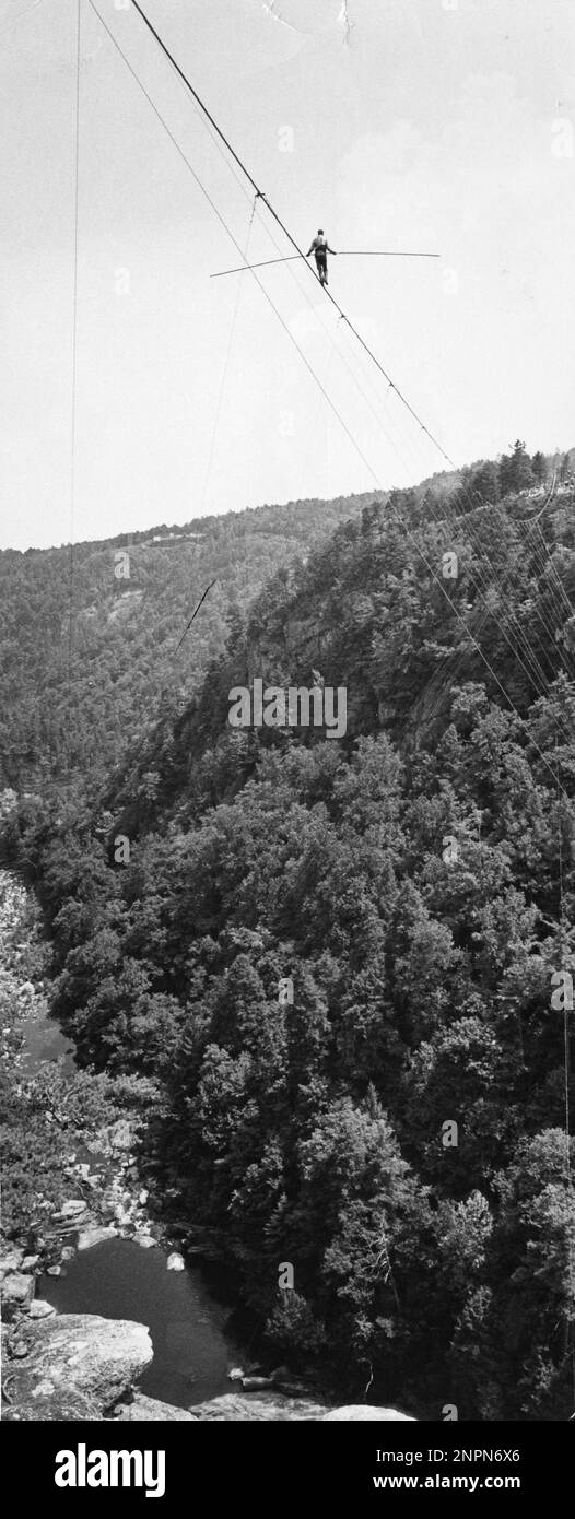 Karl Wallenda, perched hundreds of feet in air, walks on a tightrope ...
