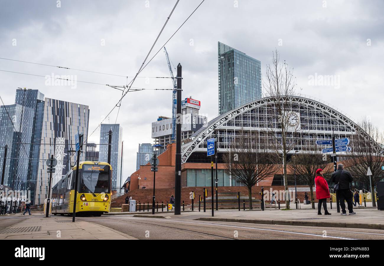 A yellow Metrolink tram passes the Manchester Central Convention ...