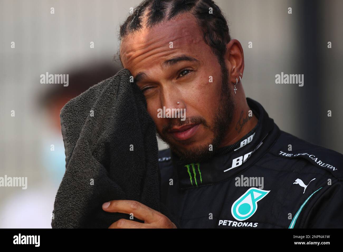 Mercedes driver Lewis Hamilton of Britain wipes his face after the 70th ...