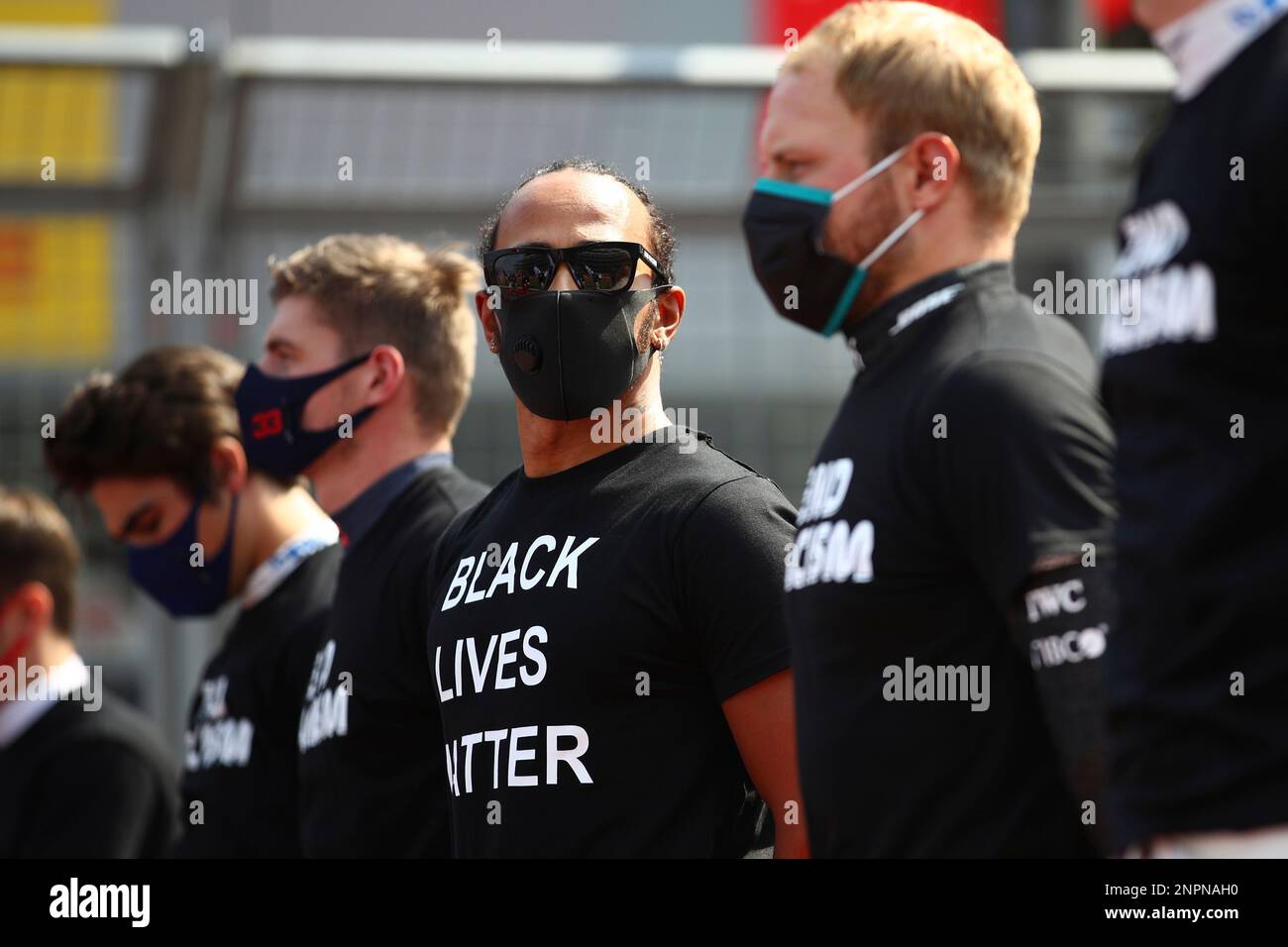 Mercedes driver Lewis Hamilton of Britain, center, wears a face mask ahead of the 70th ...