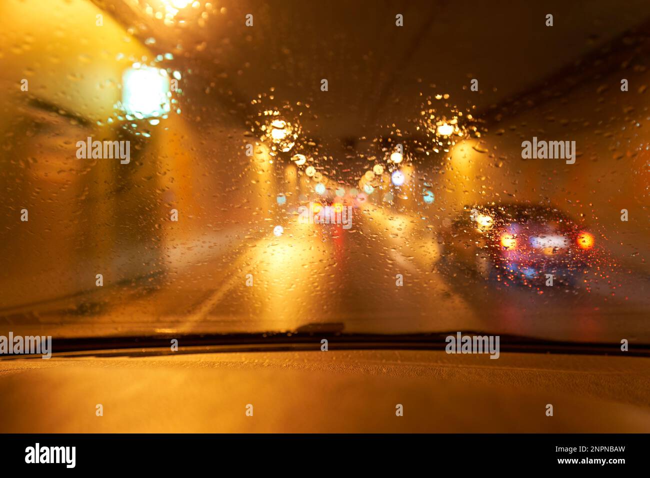 Driving a car in poor visibility and wet road. Raindrops on the ...