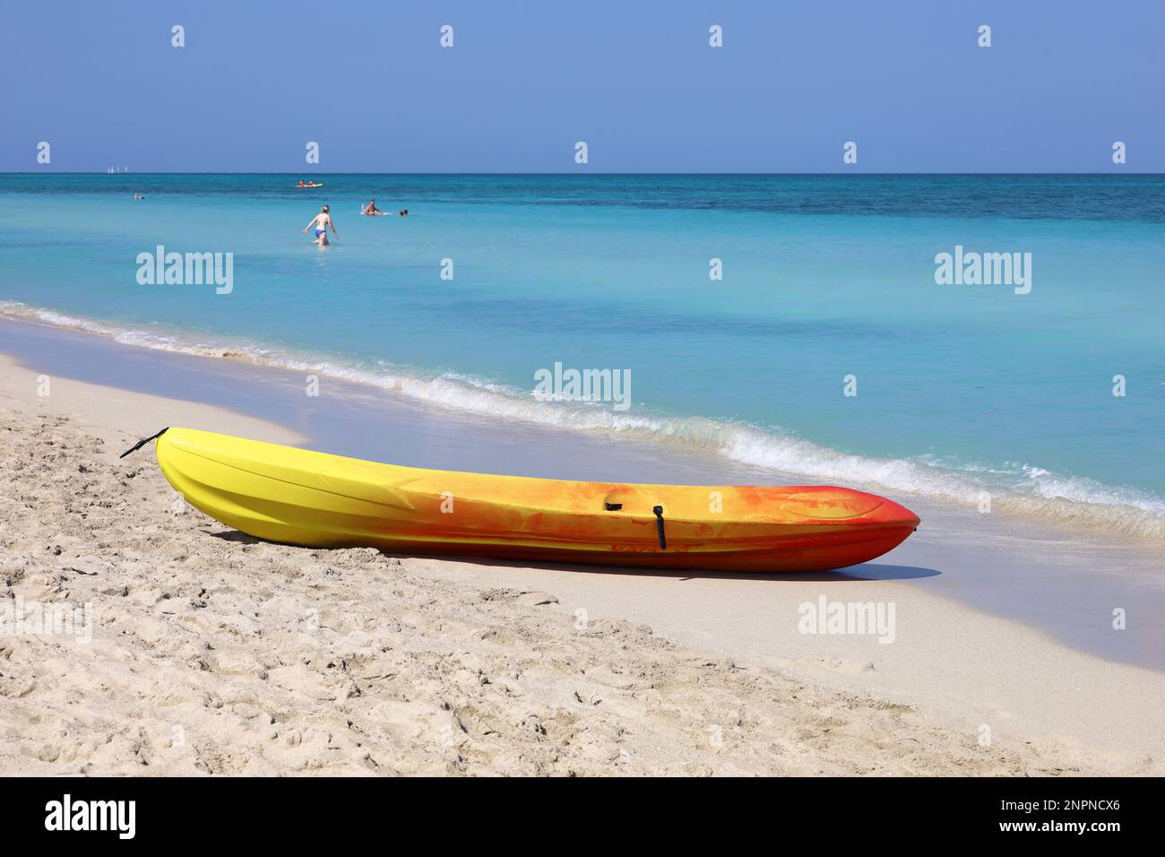 Yellow red kayak on the sand of ocean beach. Tropical coast with people ...