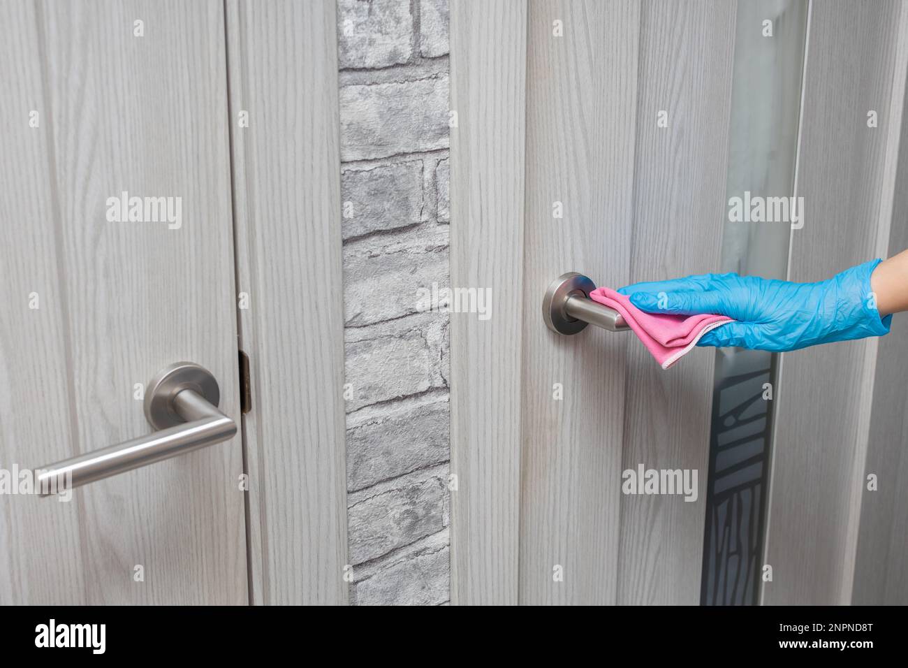 man wiping a doorknob with a rag. wet house cleaning. house cleaning ...